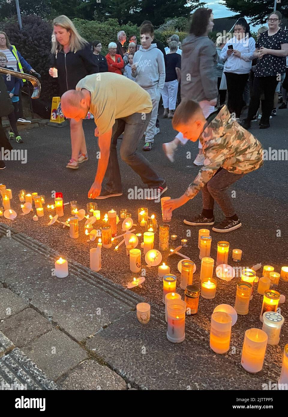 People lay candles at St Oliver Plunkett church in Strathfoyle at a ...