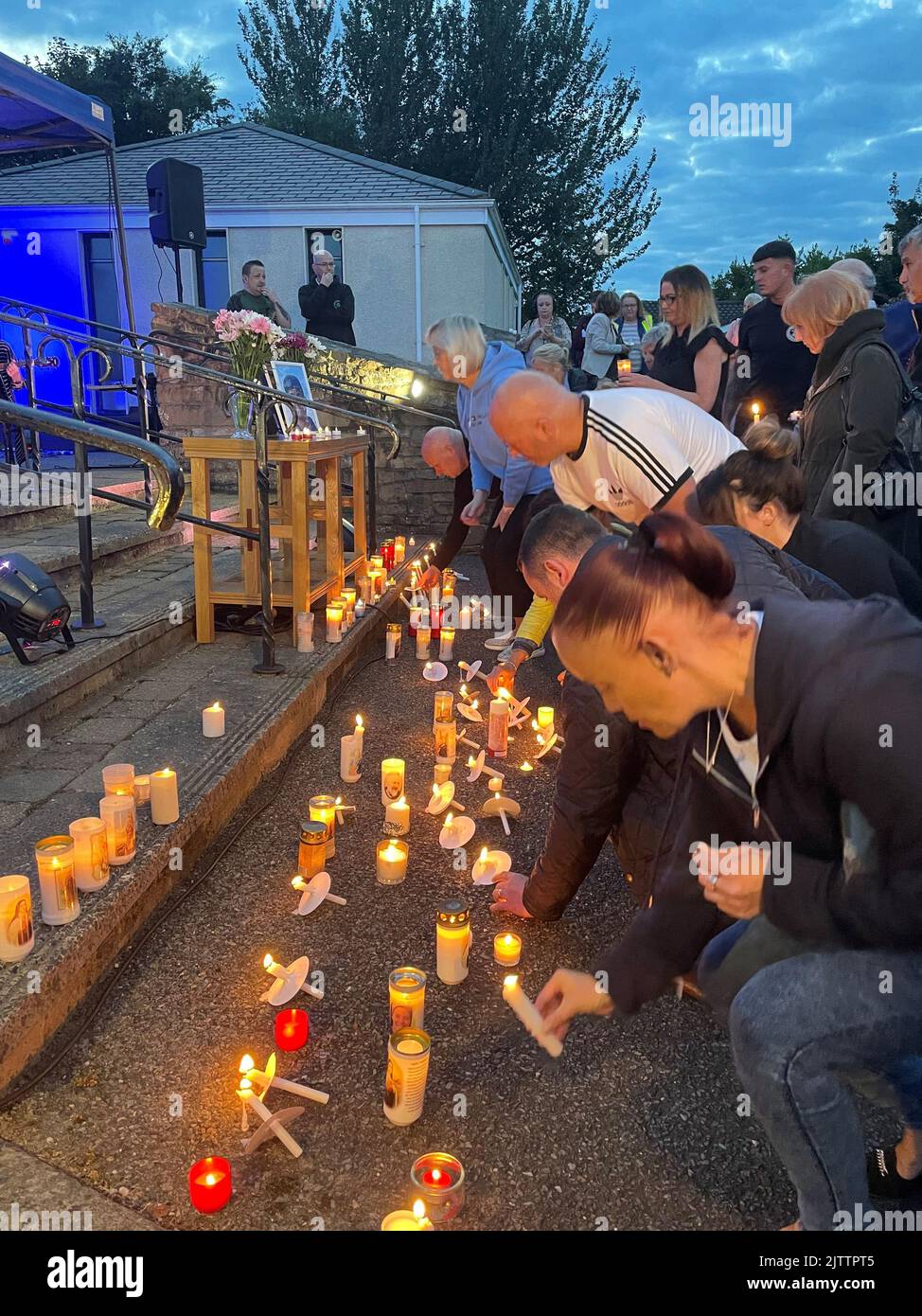 People lay candles at St Oliver Plunkett church in Strathfoyle at a ...
