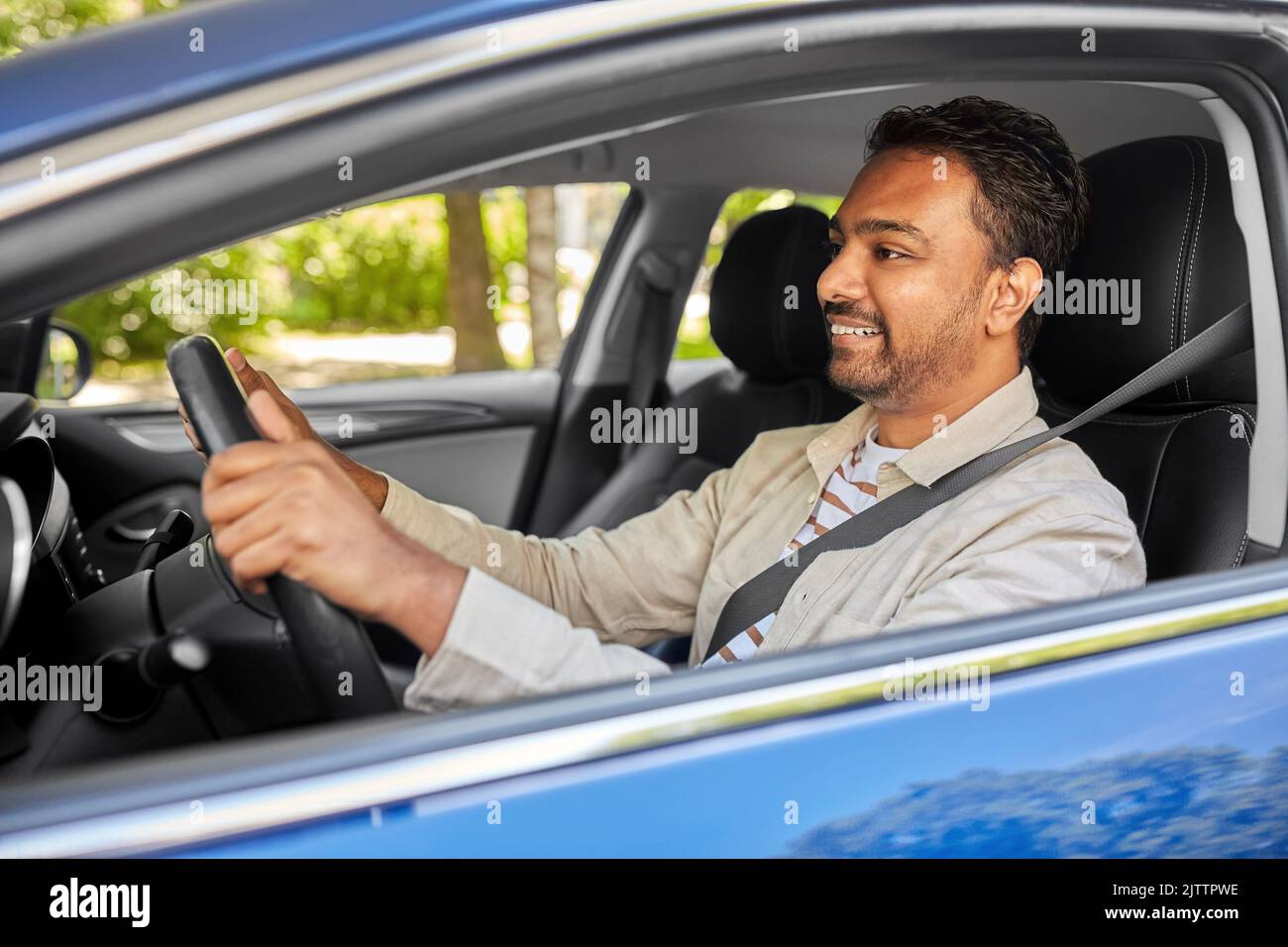 smiling indian man or driver driving car Stock Photo - Alamy