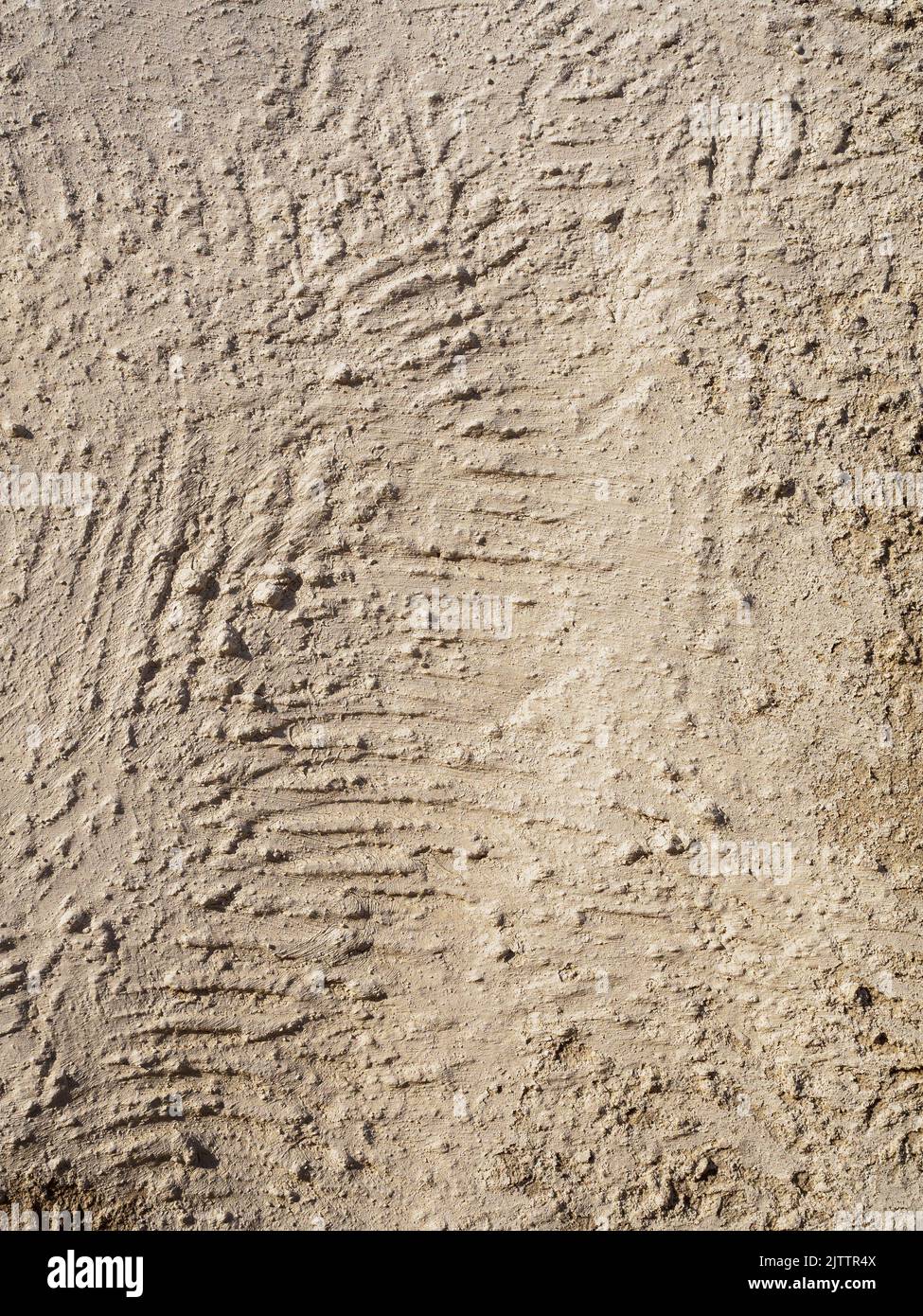 Beige textured wall with plaster applied with putty knife in irregular ...