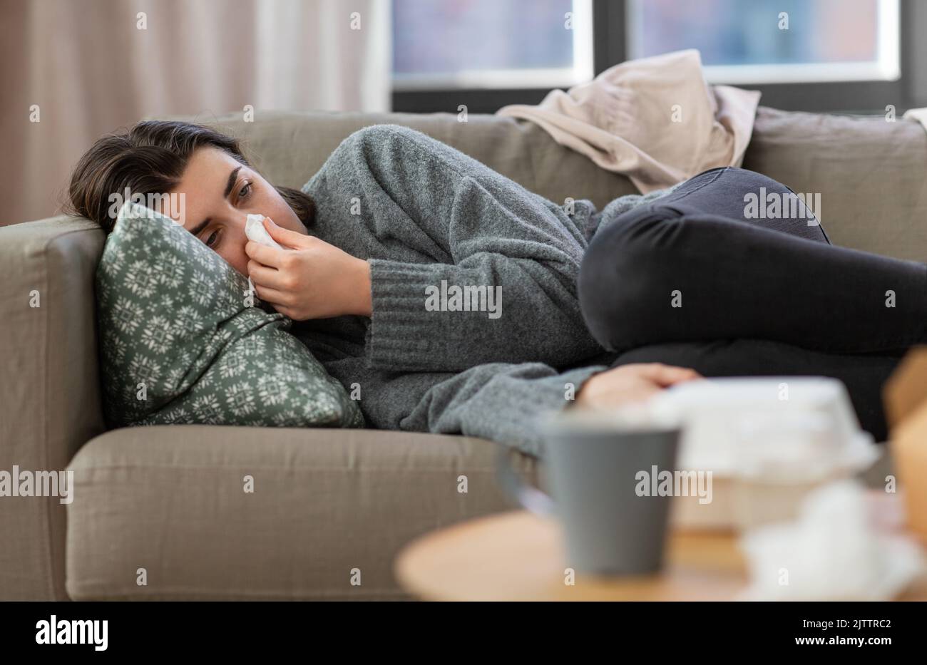 sad crying woman with tissue lying on sofa at home Stock Photo - Alamy