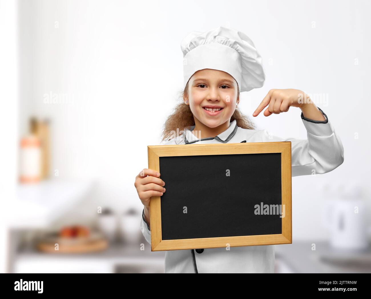 happy little girl in chef's toque with chalkboard Stock Photo - Alamy