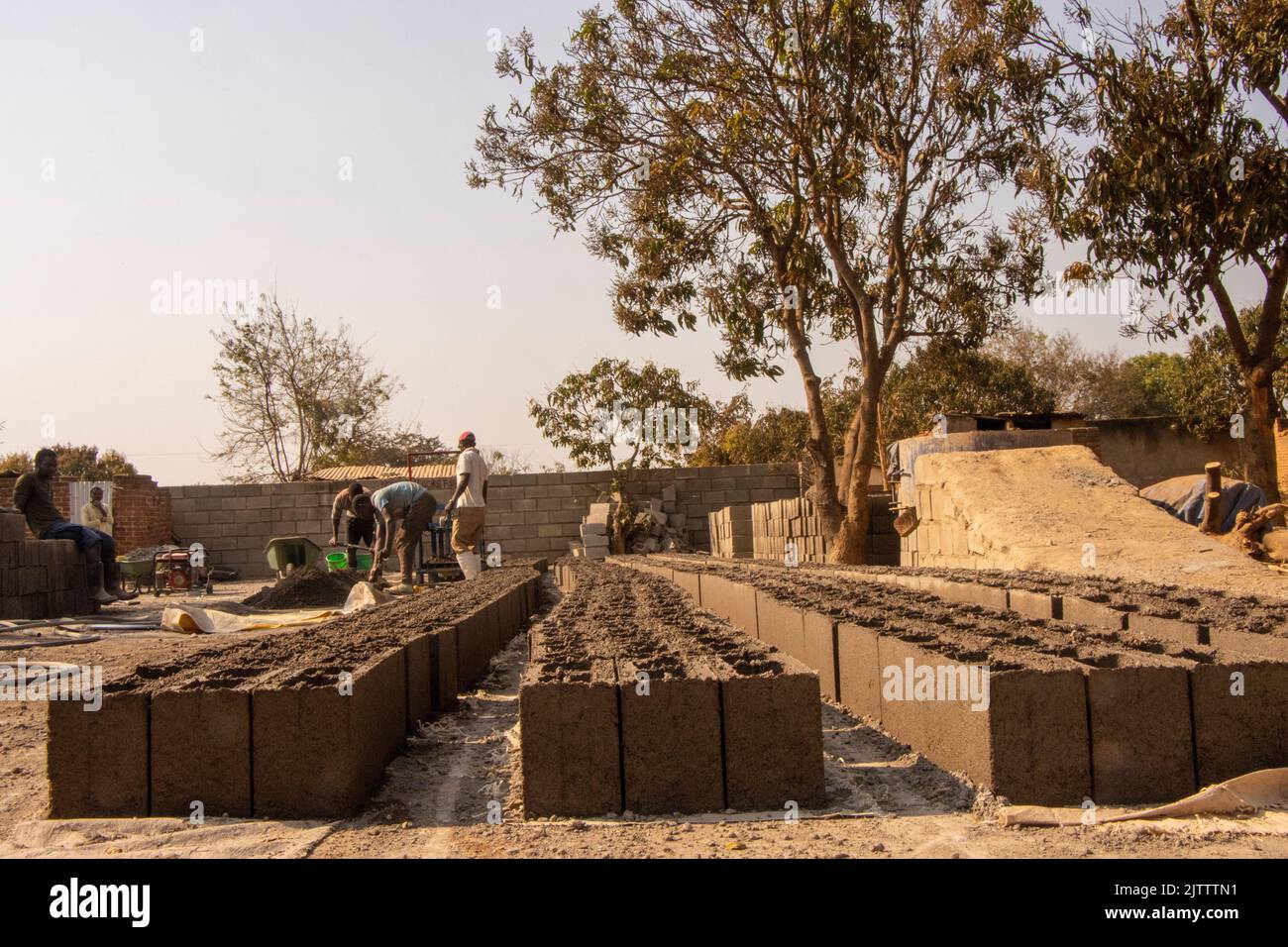 Men are seen working at a brick-making place in Area 49 Habitat ...
