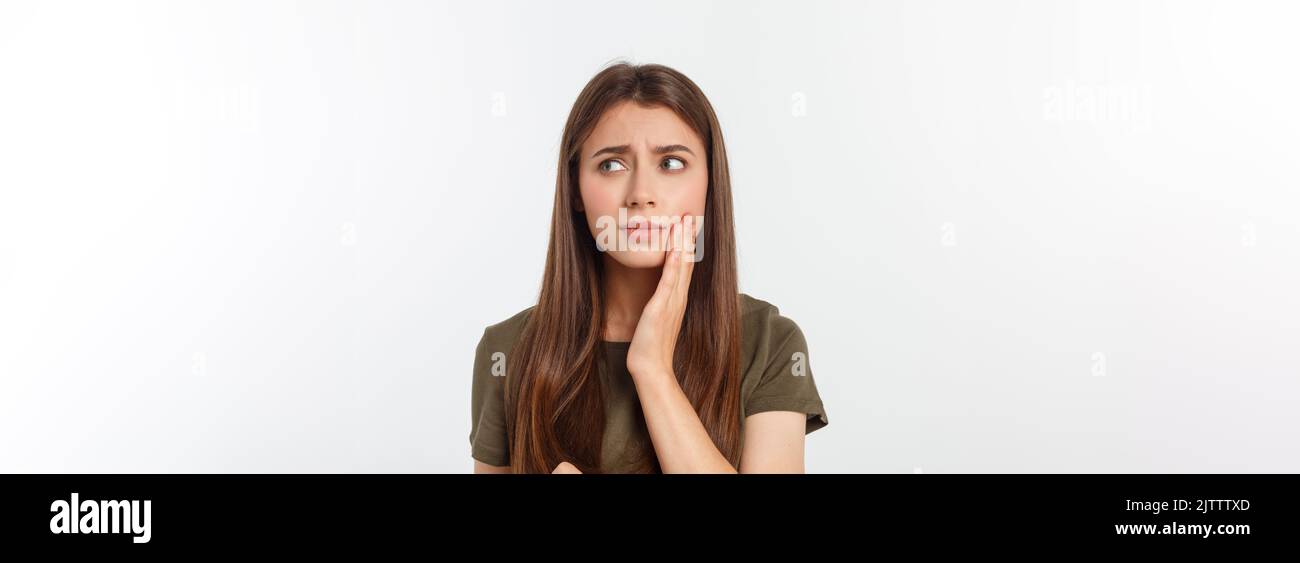 Teen woman pressing her bruised cheek with a painful expression as if ...