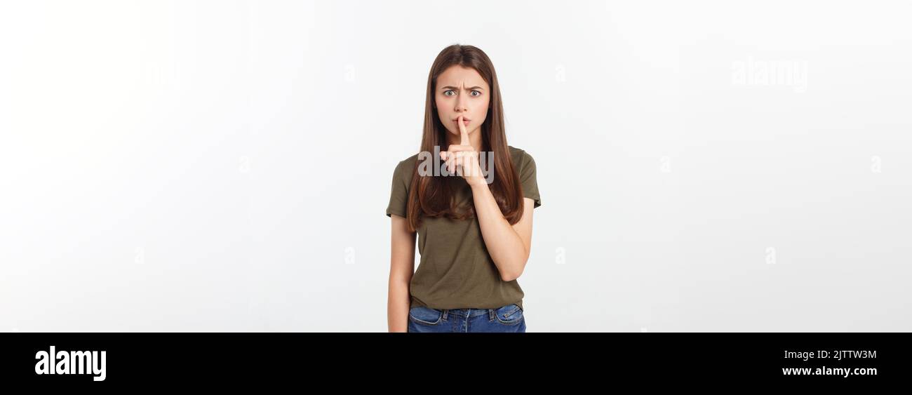 Beautiful woman showing finger over lips isolated on a white background ...
