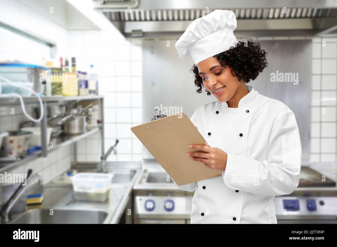 Smiling female chef clipboard hi-res stock photography and images - Alamy