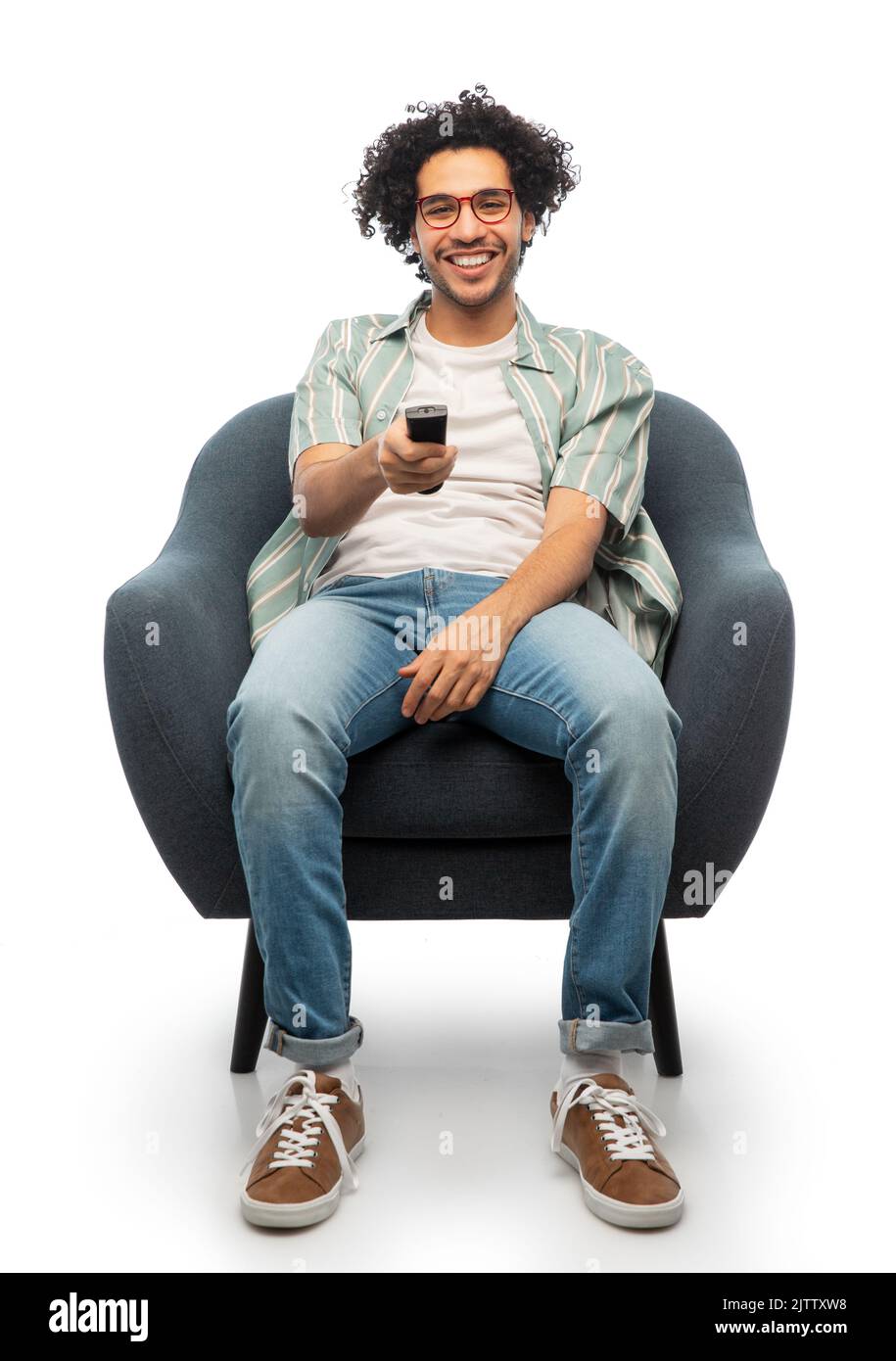 happy man with tv remote control sitting in chair Stock Photo - Alamy