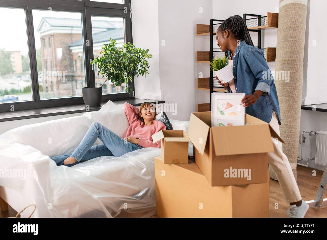 Woman unpacking boxes hi-res stock photography and images - Alamy