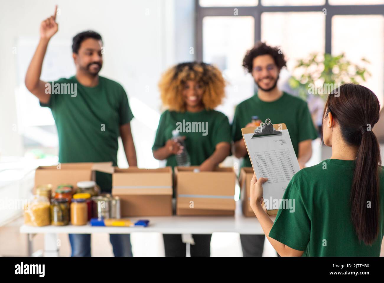 happy volunteers packing food in donation boxes Stock Photo - Alamy