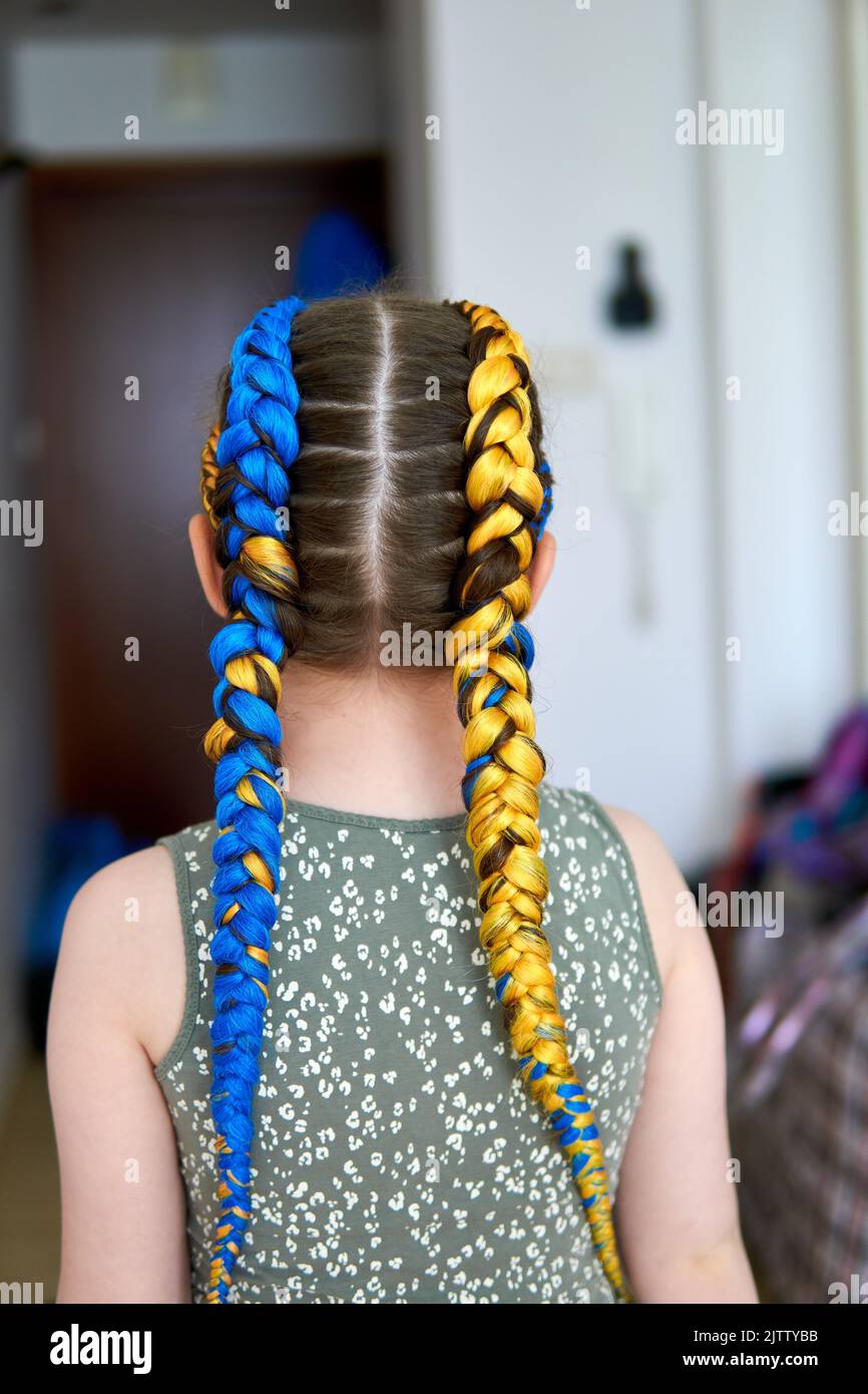 A young girl showing her support for Ukraine by wearing Dutch braids in ...
