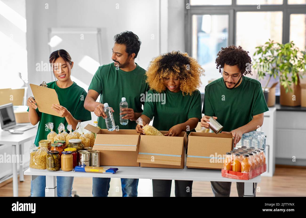 happy volunteers packing food in donation boxes Stock Photo - Alamy
