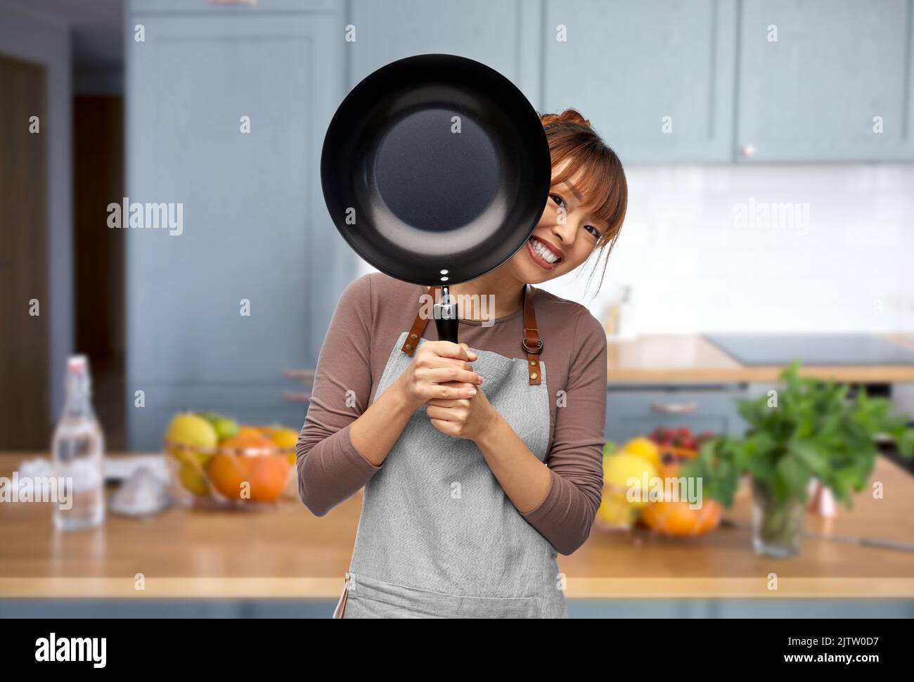 happy female chef with frying pan in kitchen Stock Photo - Alamy