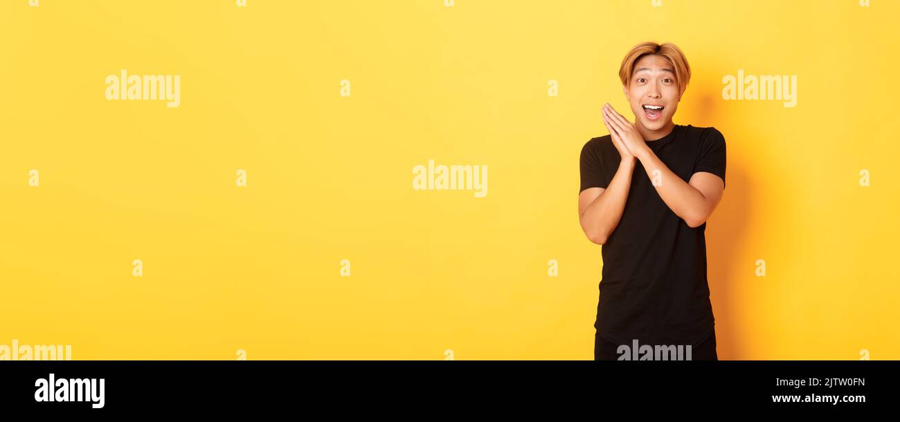 Portrait of happy and surprised asian man clap hands and smiling ...