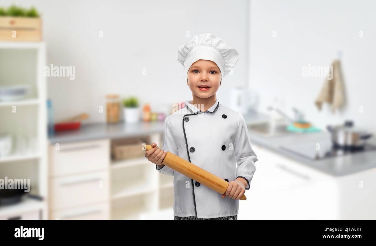 girl in chef's toque with rolling pin in kitchen Stock Photo - Alamy