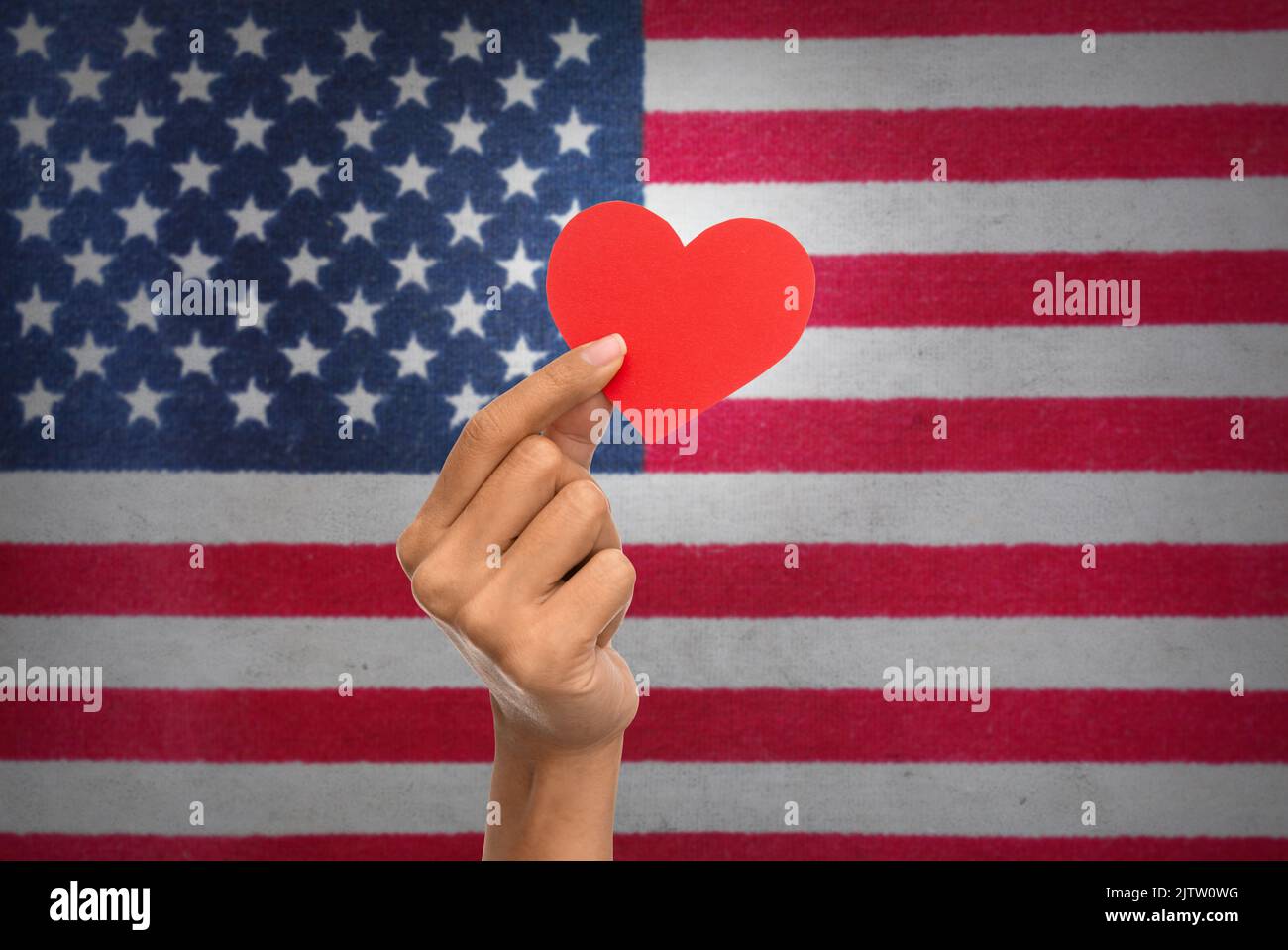 hand holding red heart over flag of america Stock Photo - Alamy