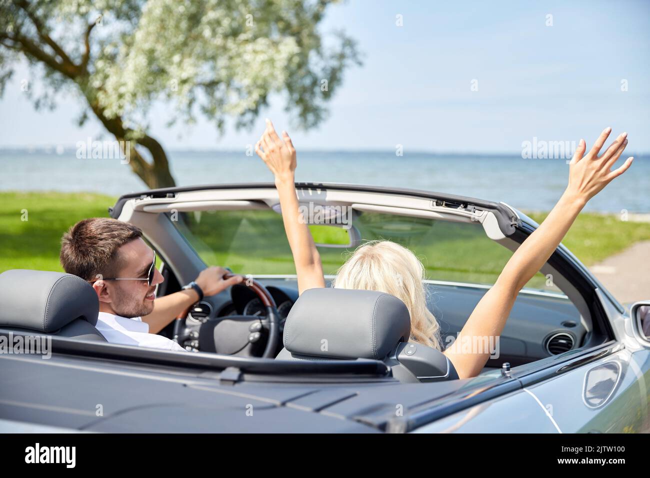 happy couple driving in convertible car Stock Photo - Alamy
