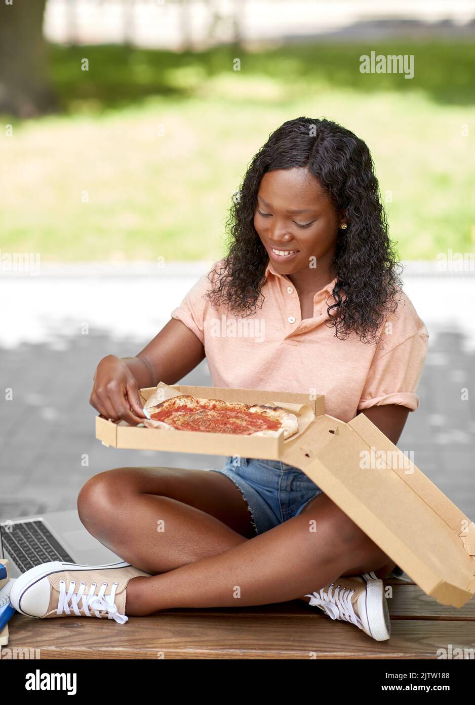 african student girl eating takeaway pizza in city Stock Photo - Alamy