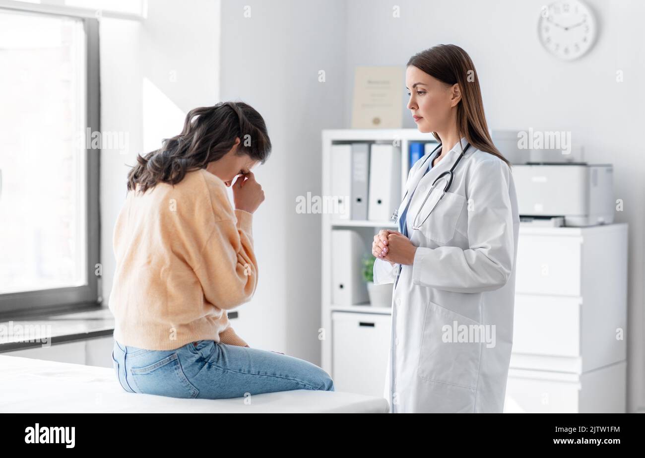 female doctor talking to sad woman at hospital Stock Photo - Alamy