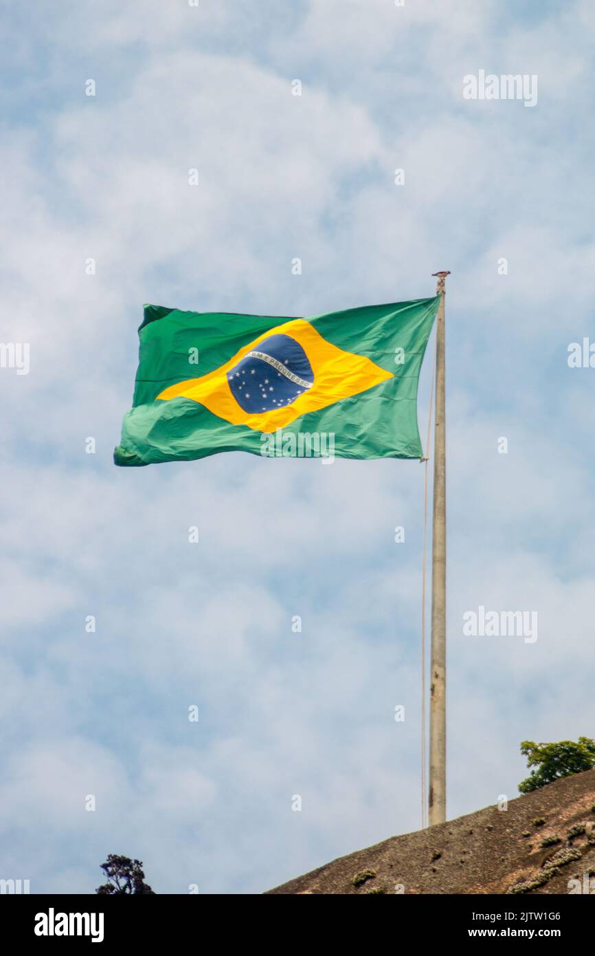 brazil flag outdoors with a beautiful blue sky in Rio de Janeiro Stock ...