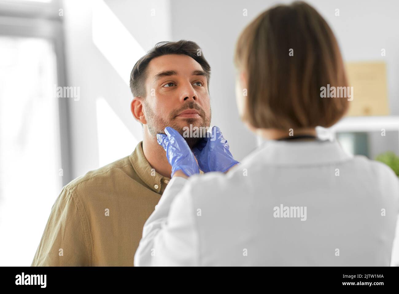 doctor checking lymph nodes of man at hospital Stock Photo - Alamy