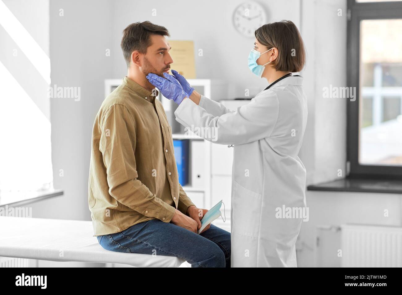 doctor checking lymph nodes of man at hospital Stock Photo - Alamy
