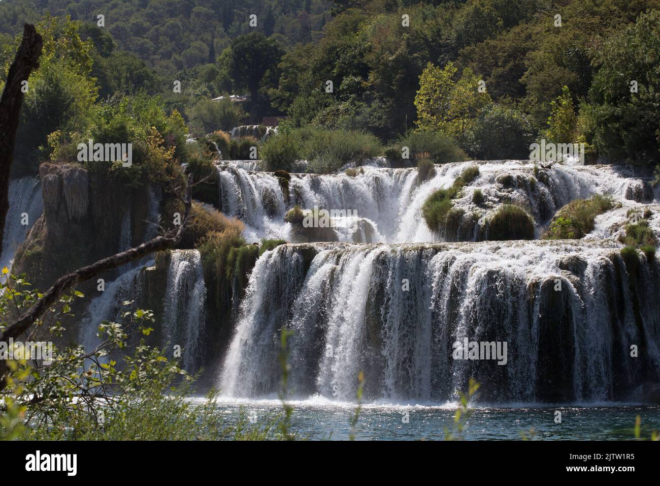 Close up of Skradinski Buk Waterfall surrounded by green trees located ...