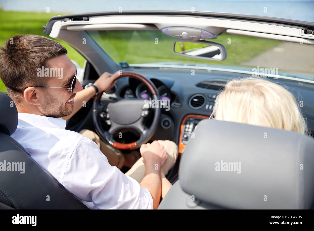 happy couple driving in convertible car Stock Photo - Alamy