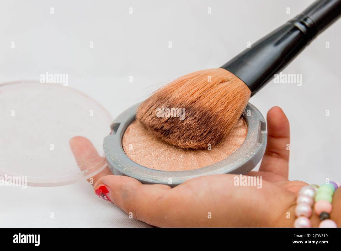 makeup, compact powder with brush on a white hand in Rio de Janeiro ...