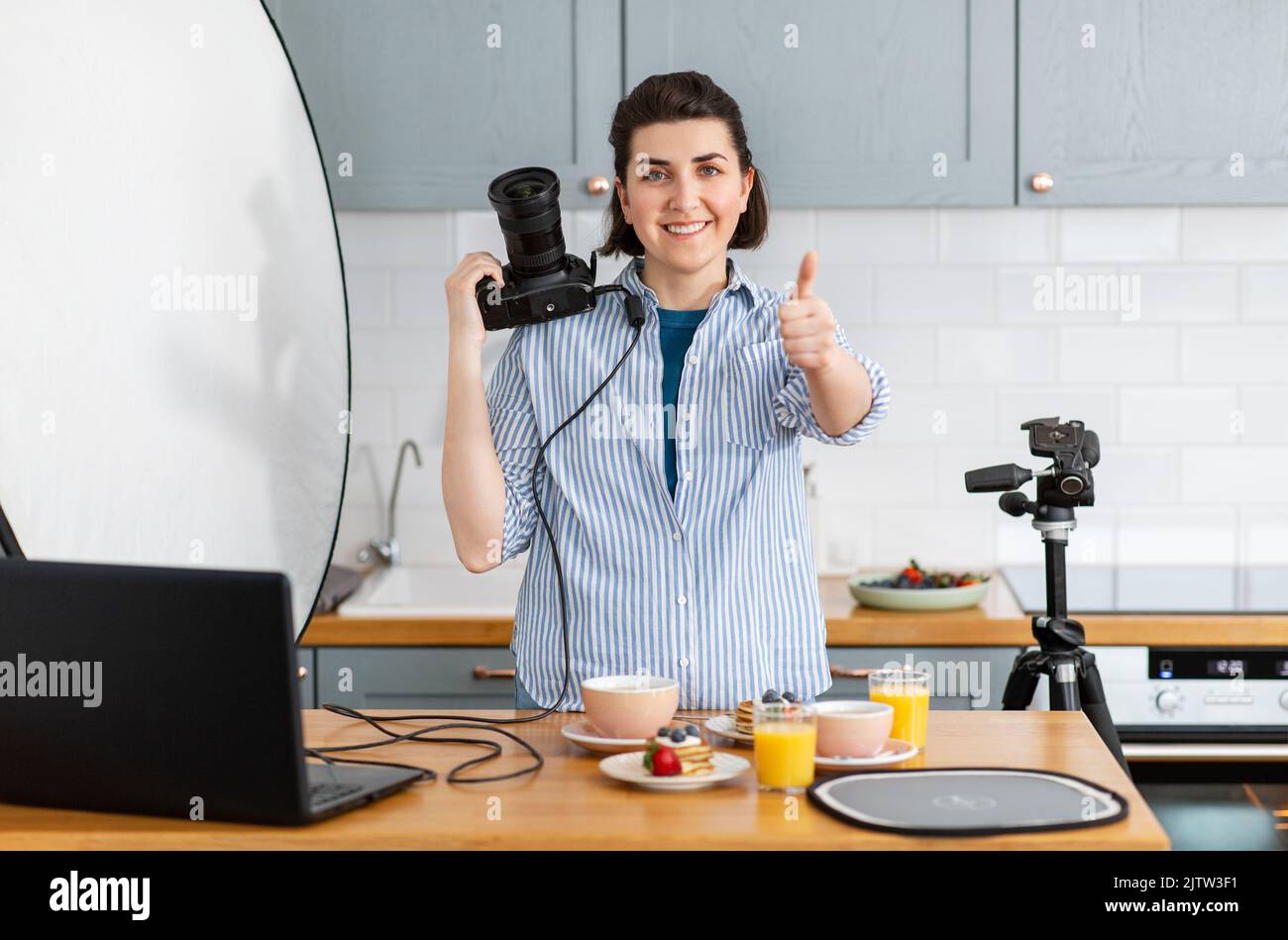 food photographer with camera working in kitchen Stock Photo - Alamy