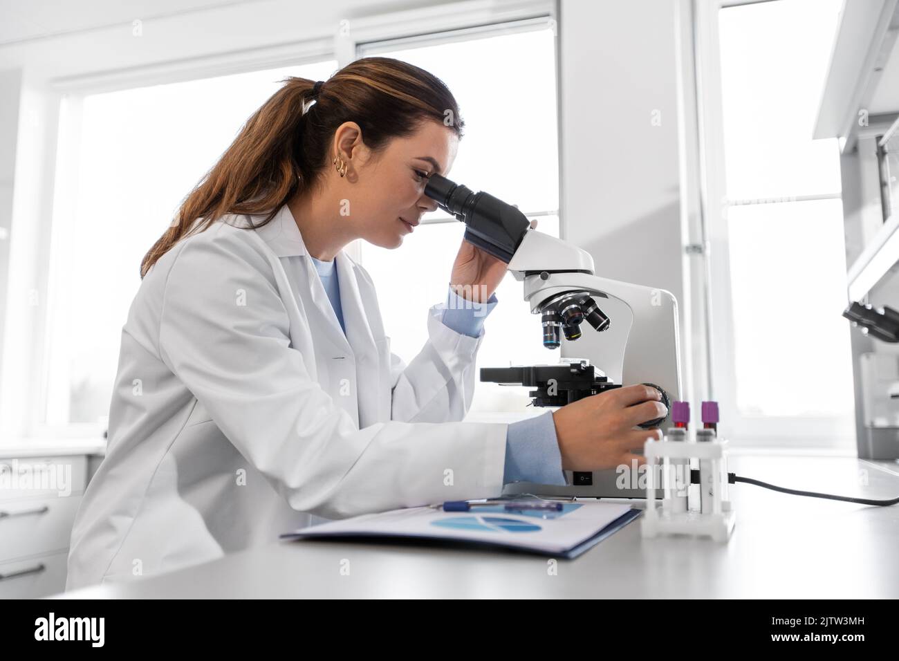 scientist with microscope working in laboratory Stock Photo - Alamy