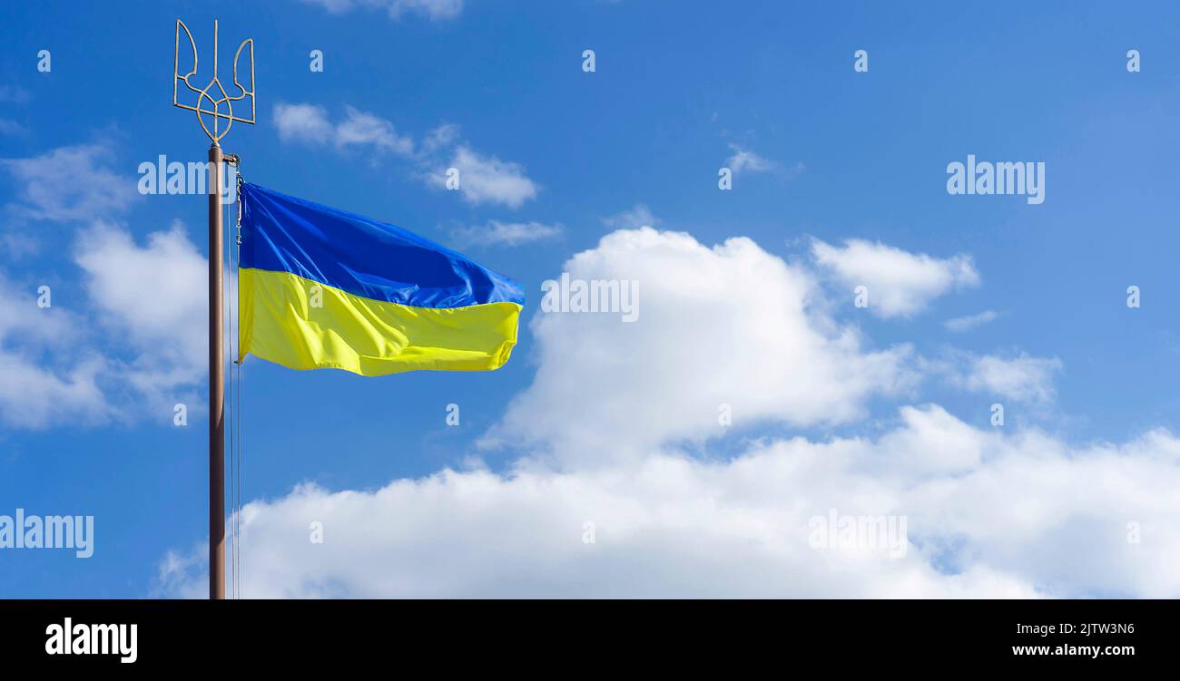 Ukraine blue yellow flag waving over blue sky with white clouds on ...