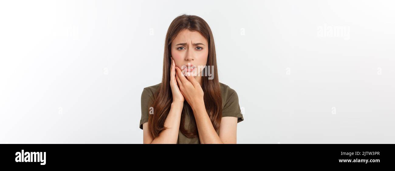 Teen woman pressing her bruised cheek with a painful expression as if ...