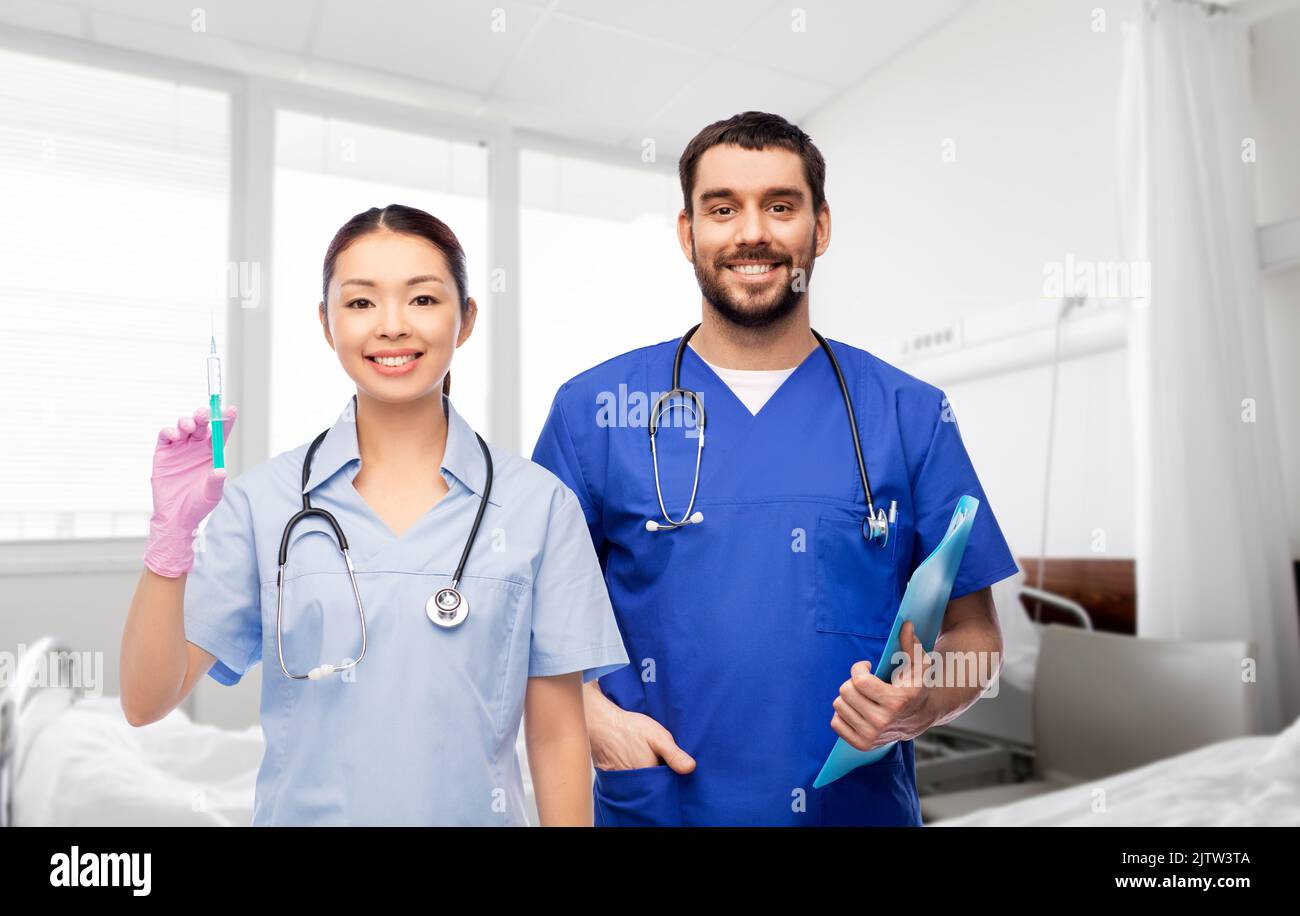 happy smiling doctors or nurses at hospital ward Stock Photo - Alamy