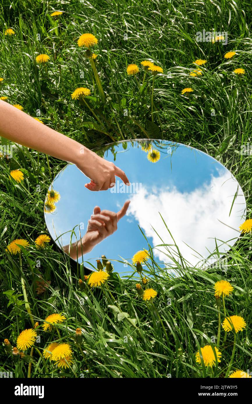 hand touching sky reflection in mirror on field Stock Photo - Alamy