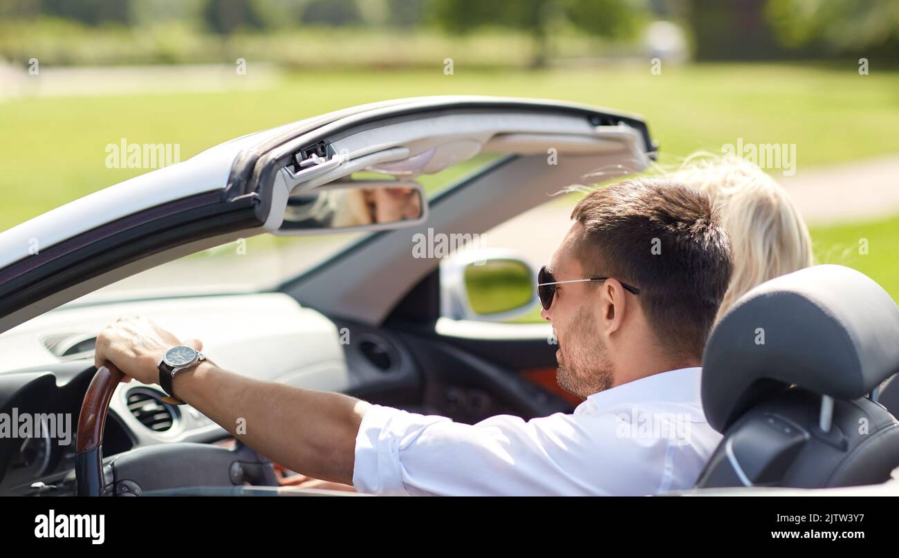happy couple driving in convertible car Stock Photo - Alamy