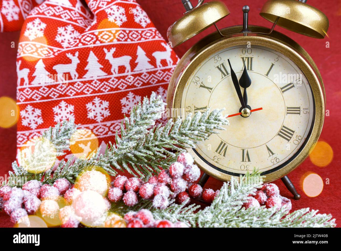 New year red background with snow fir christmas tree, alarm clock and ...