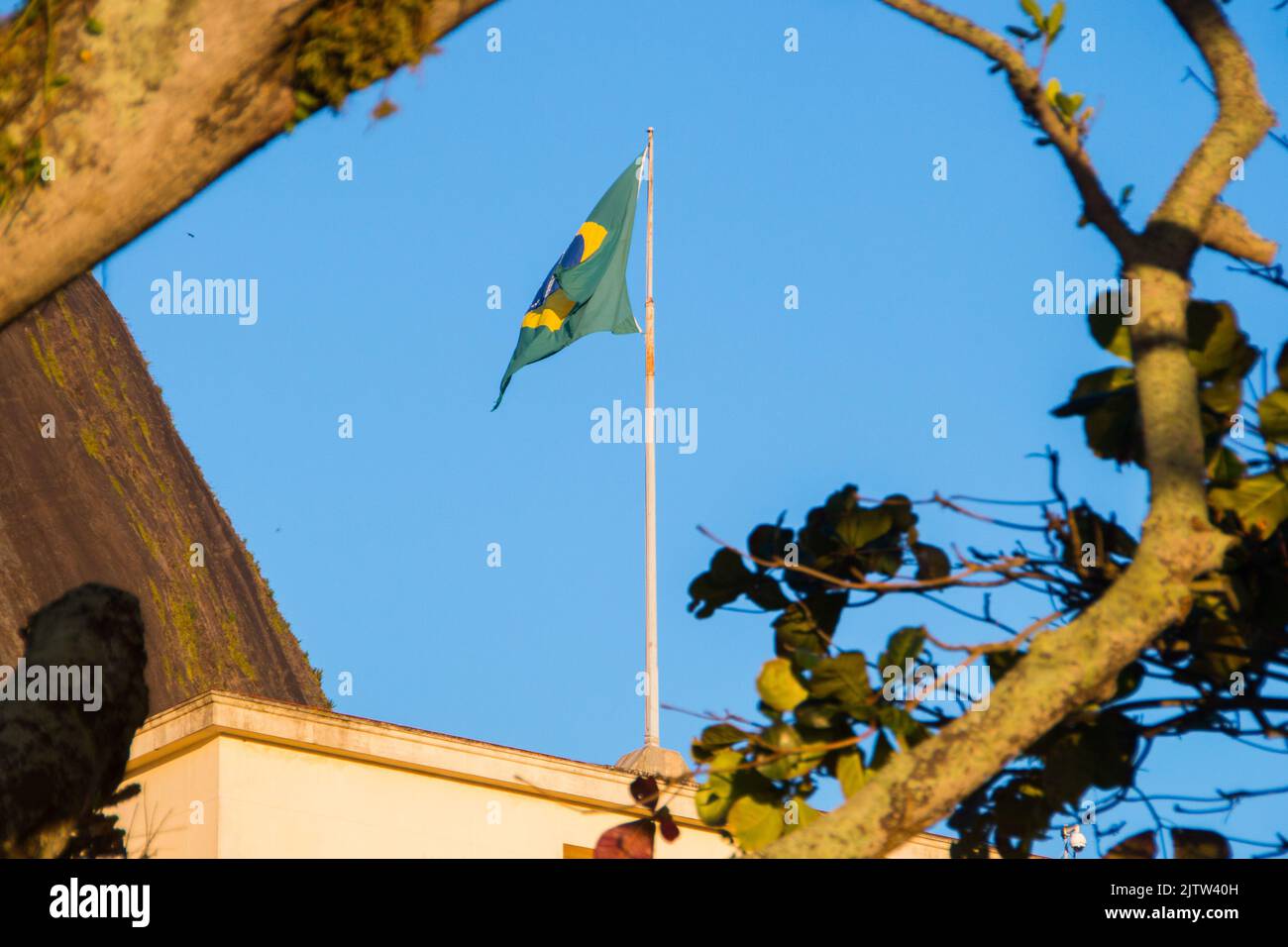 Flag of Brazil outdoors with a beautiful blue sky in the background in ...