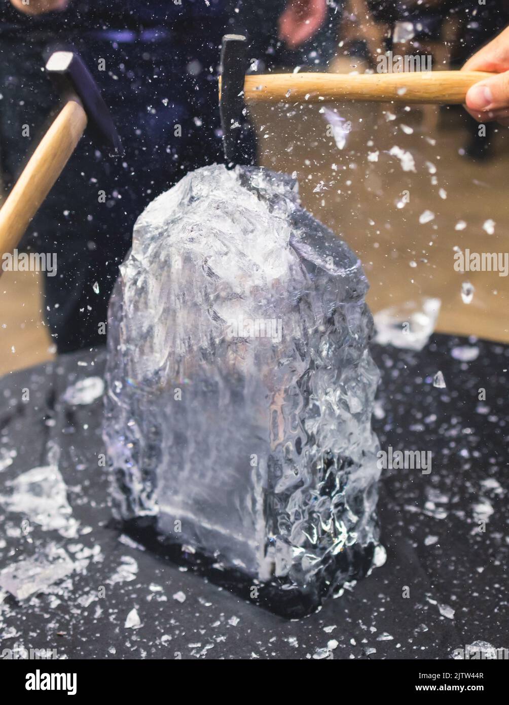 Process of breaking the ice with hammer and ice pick, group of people ...