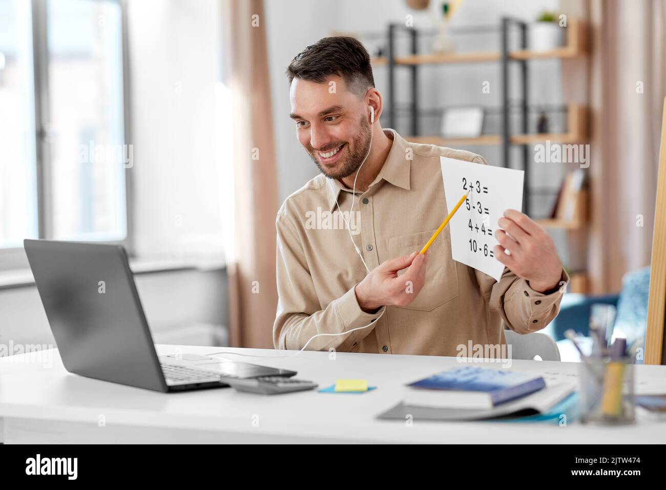 male math teacher having online class at home Stock Photo - Alamy