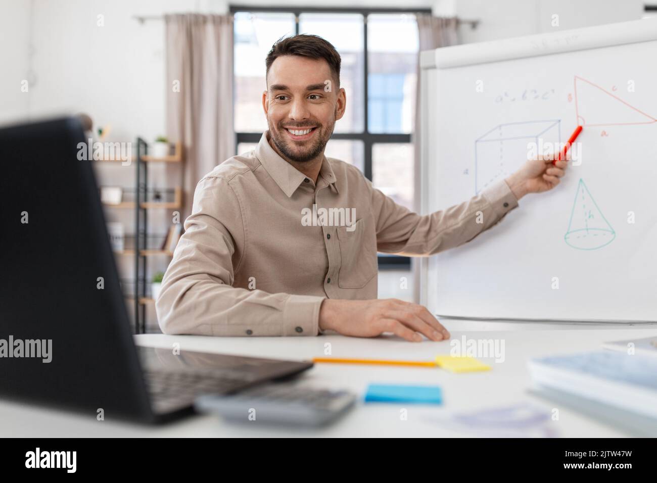 math teacher with laptop has online class at home Stock Photo - Alamy