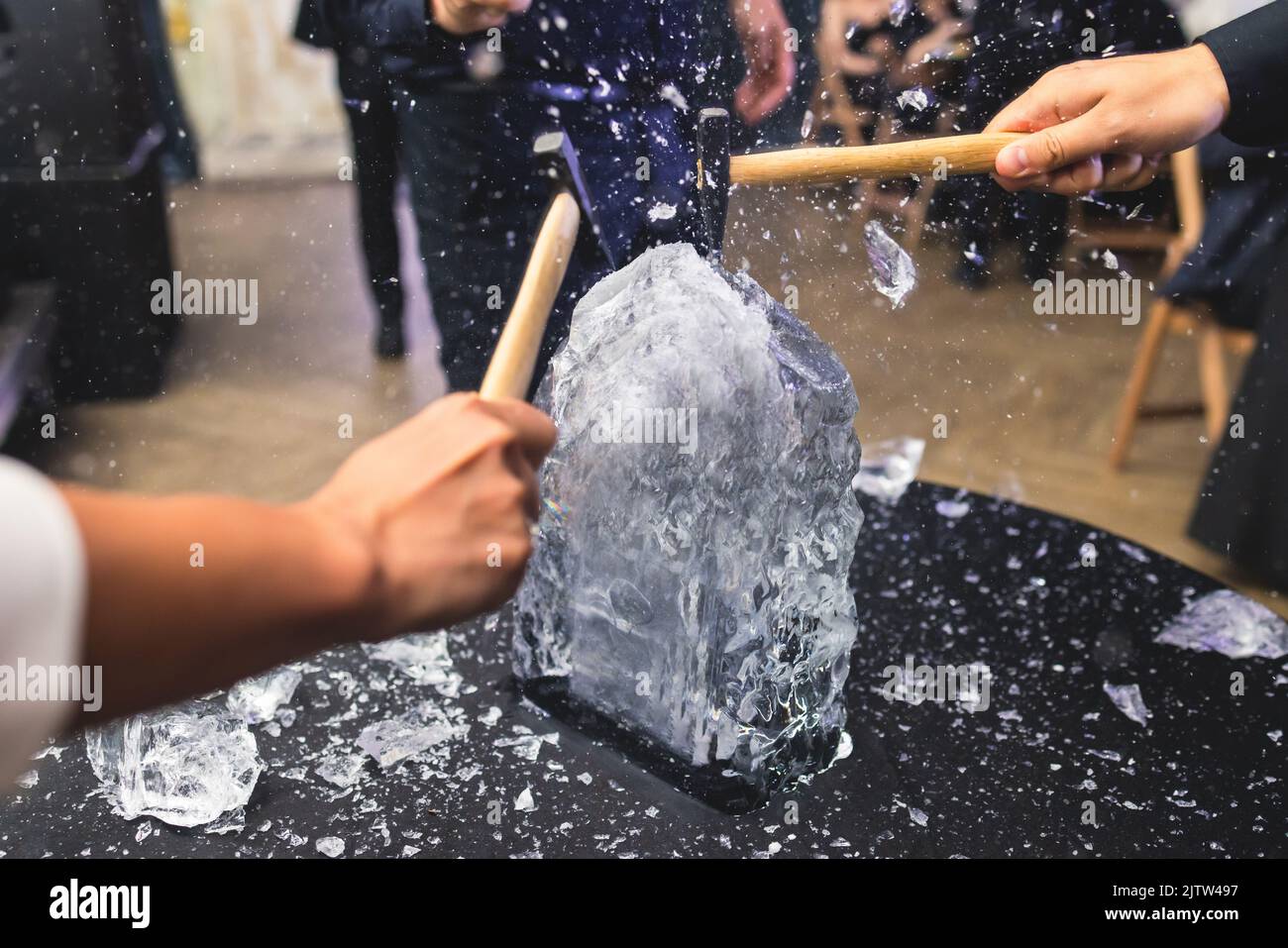 Process of breaking the ice with hammer and ice pick, group of people ...