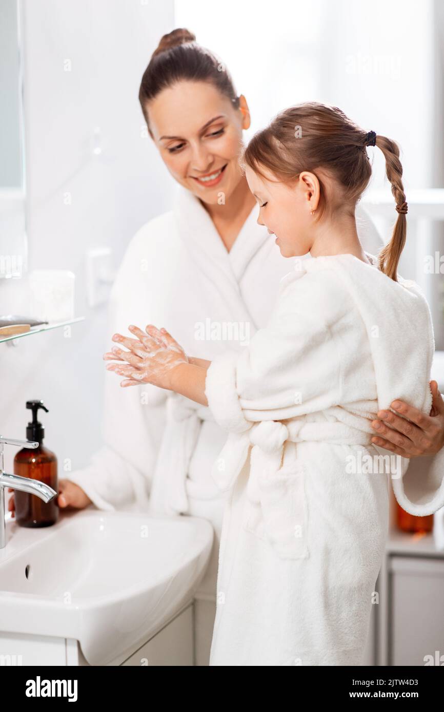 mother and daughter with liquid soap in bathroom Stock Photo - Alamy