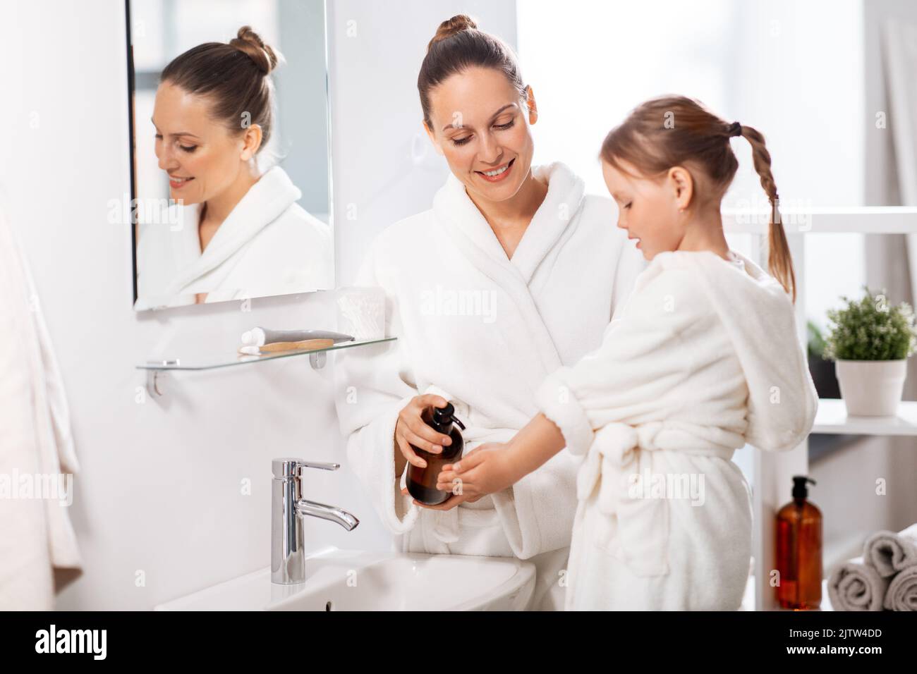 mother and daughter with liquid soap in bathroom Stock Photo - Alamy