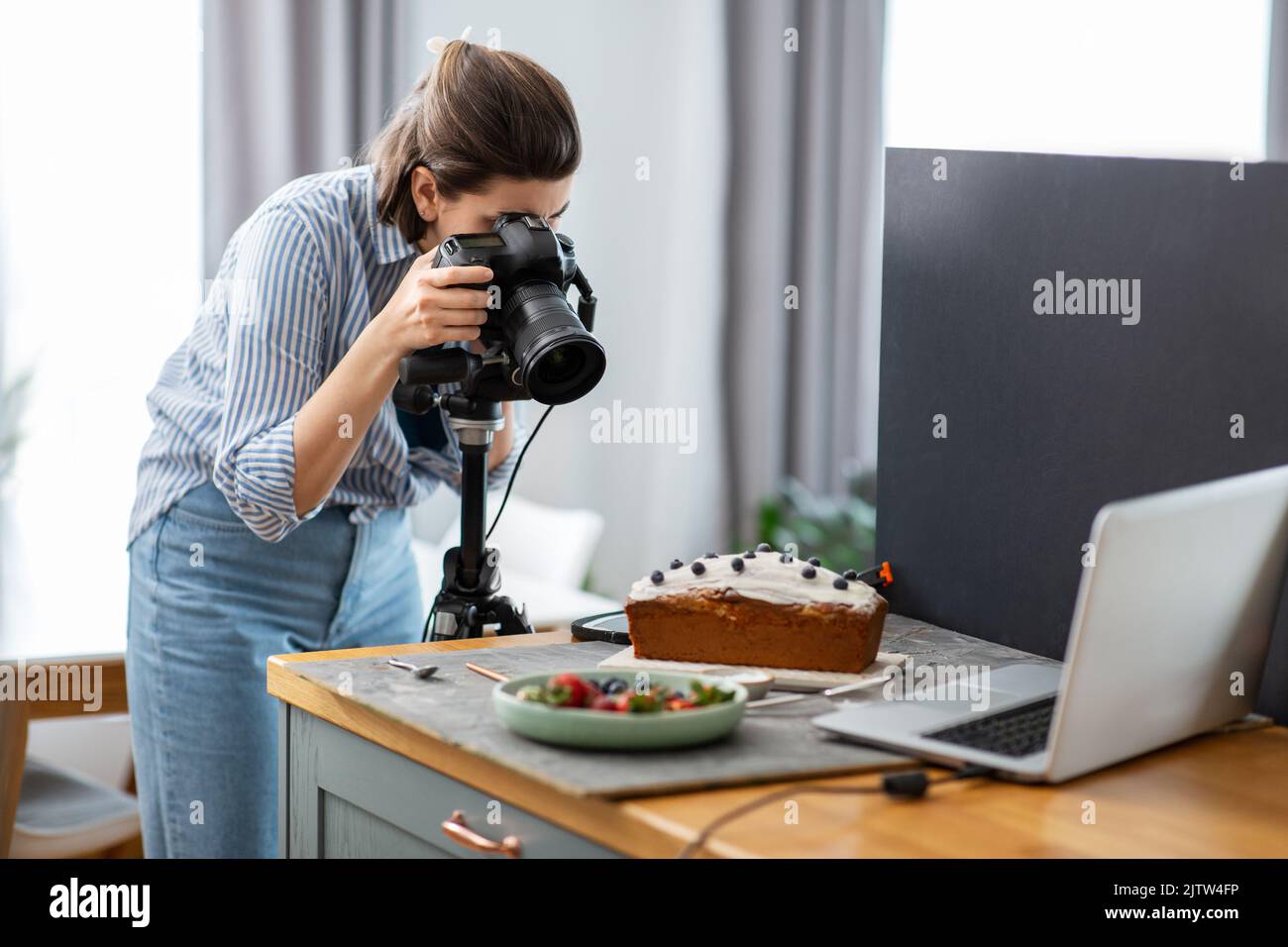 food photographer with camera working in kitchen Stock Photo - Alamy