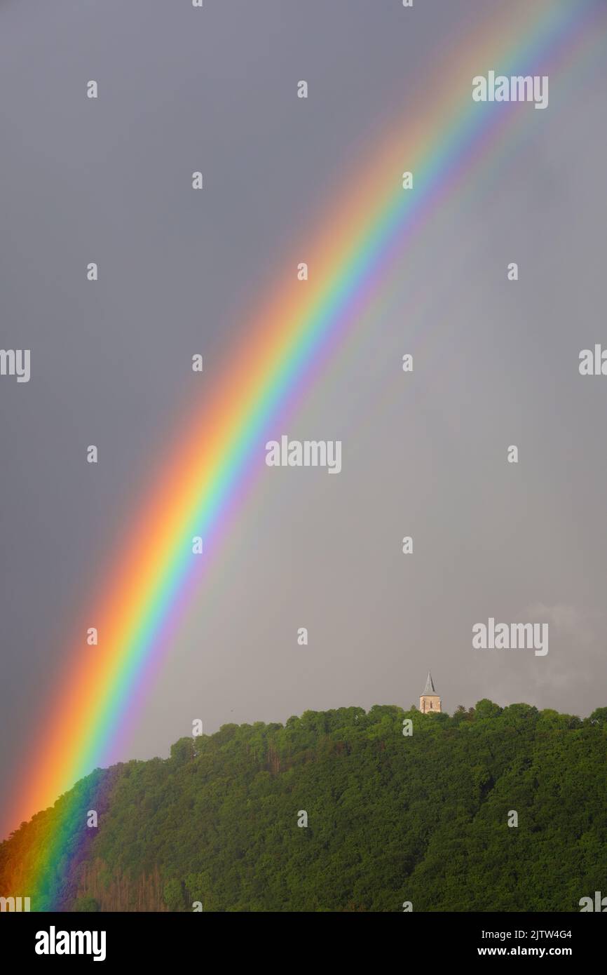 a vertical shot of a rainbow under overcast sky Stock Photo - Alamy