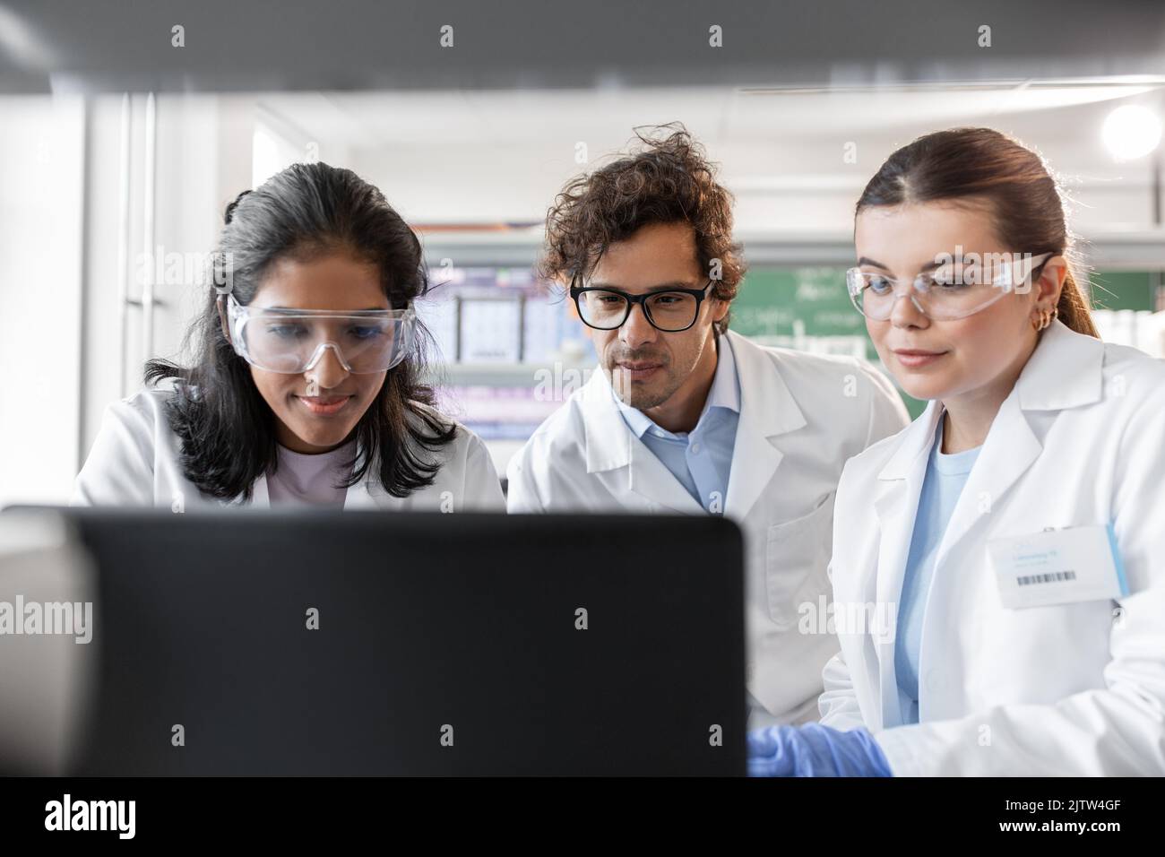 scientists with laptop working in laboratory Stock Photo - Alamy