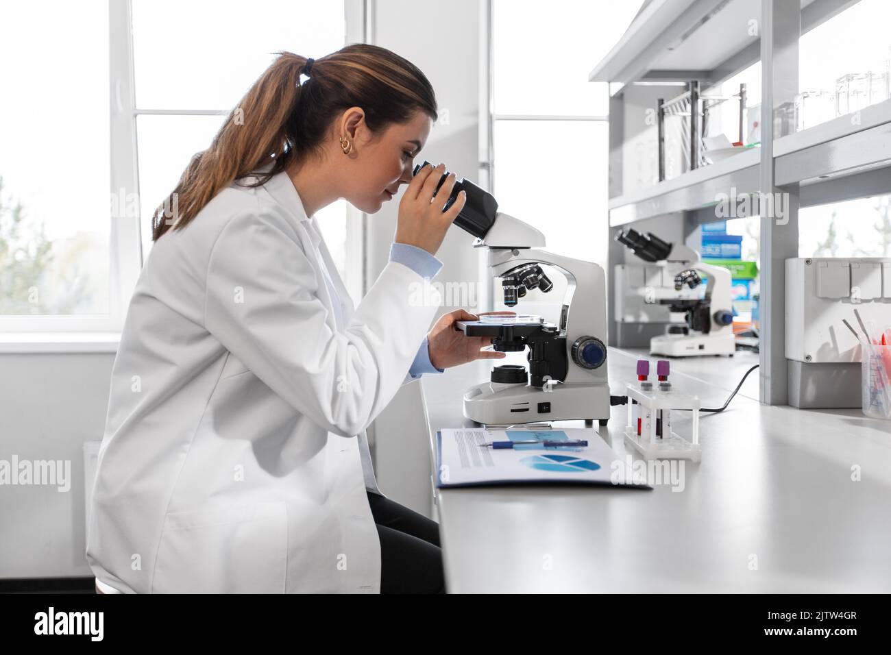 scientist with microscope working in laboratory Stock Photo - Alamy