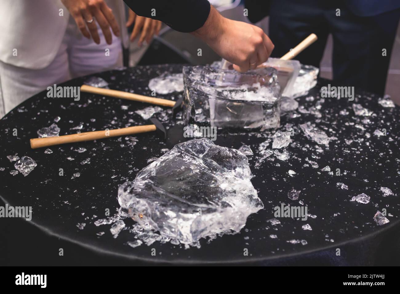 Process of breaking the ice with hammer and ice pick, group of people ...