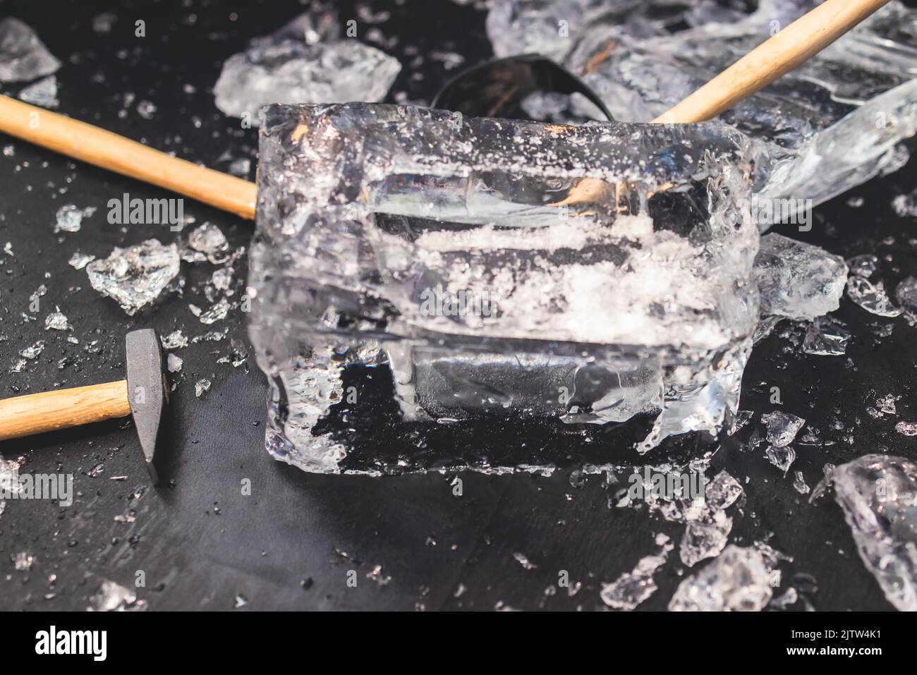 Process of breaking the ice with hammer and ice pick, group of people ...