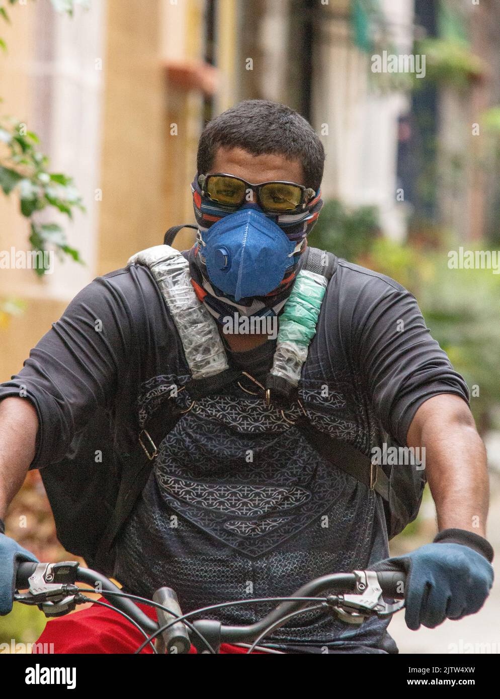 black man delivering food by bicycle on a street in Rio de Janeiro ...